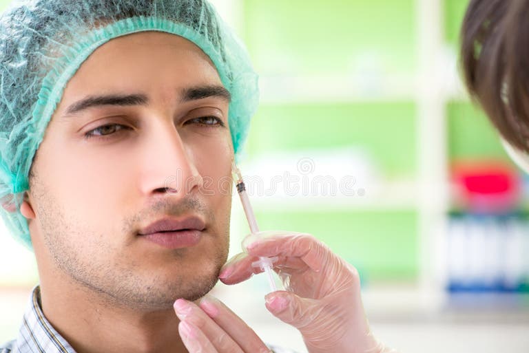 The Plastic Surgeon Preparing for Operation on Man Face Stock Image ...
