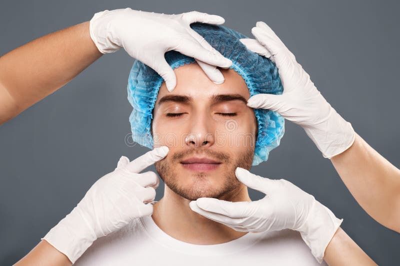 Doctor& X27;s Hands in Gloves Checking Face of Young Man Stock Photo ...