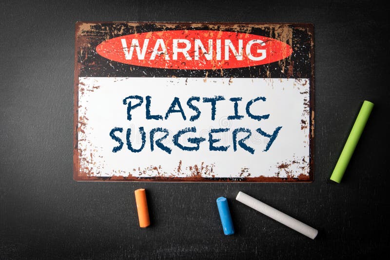 Plastic Surgery. Metal Warning Sign and Colored Pieces of Chalk on a ... Plastic Surgery. Metal Warning Sign and Colored Pieces of Chalk on a ...