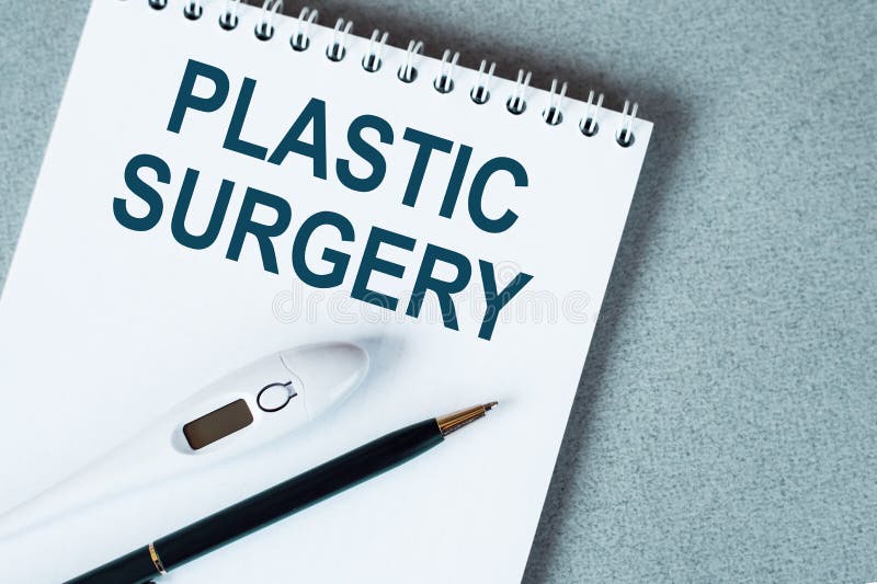 PLASTIC SURGERY is Written in a White Notebook on a Gray Table with a ...