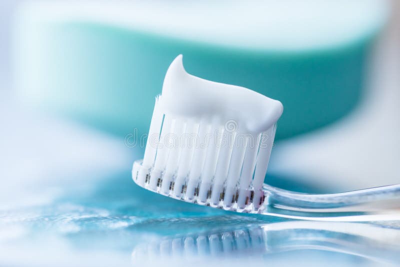 Plastic Toothbrush with White Toothpaste on a Blue Table Stock Image ...