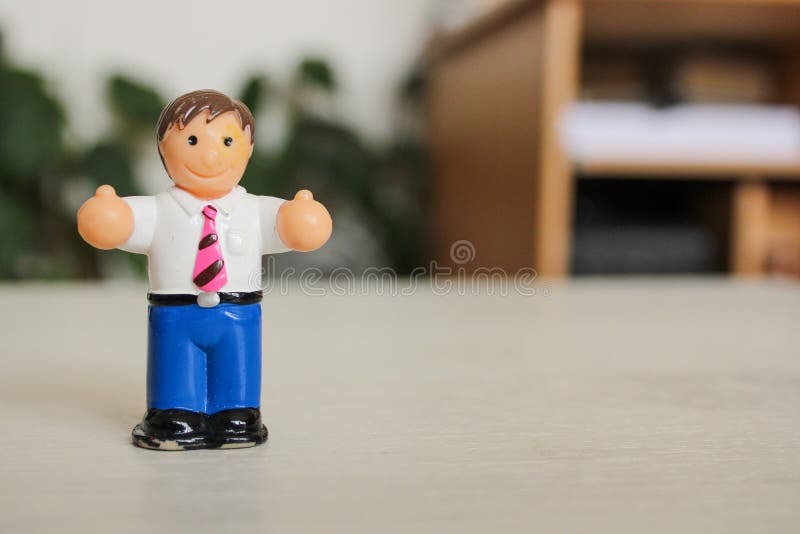 Plastic toy businessman stock image. Image of yellow - 226458211