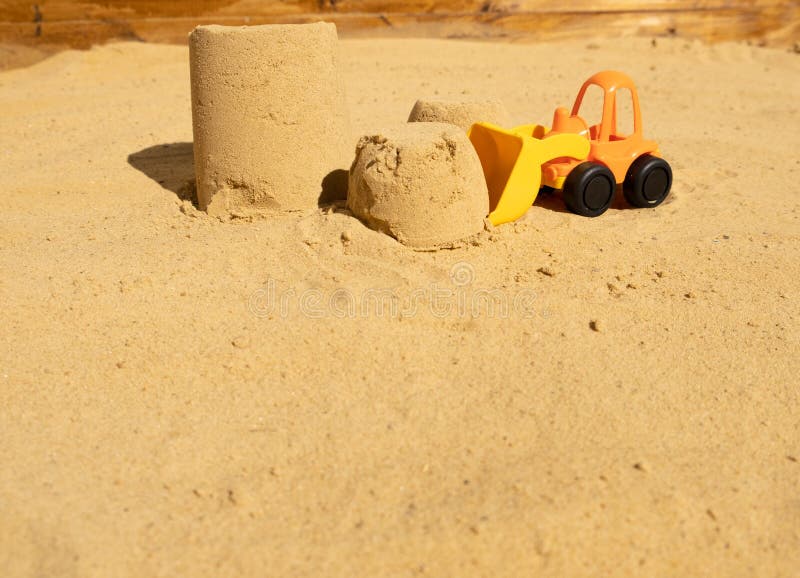 Plastic Toy Tractor with Bucket Building Sand Towers in the Sandbox ...