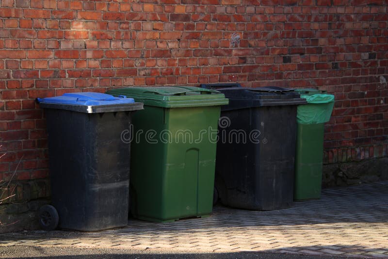 Garbage Cans Against a Brick Wall Stock Image - Image of fence ...