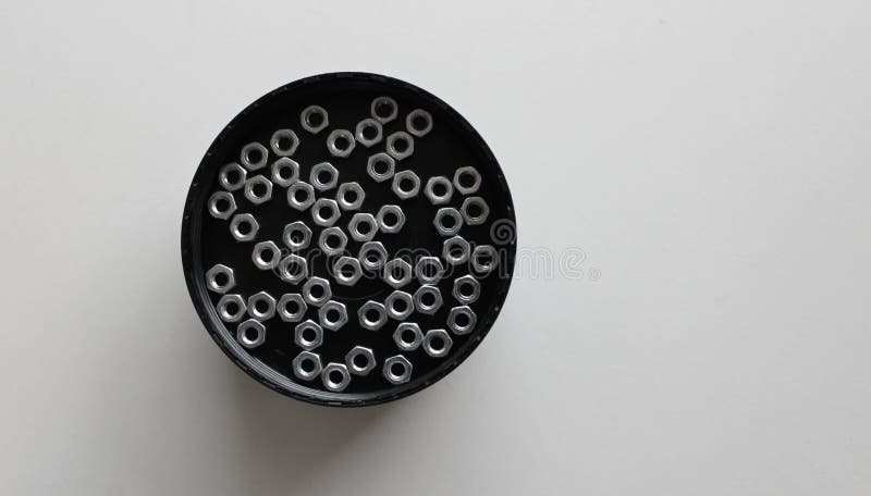 Plastic Tray with Scattered Hex Nuts on Clean White Plastic Sheet Stock ...