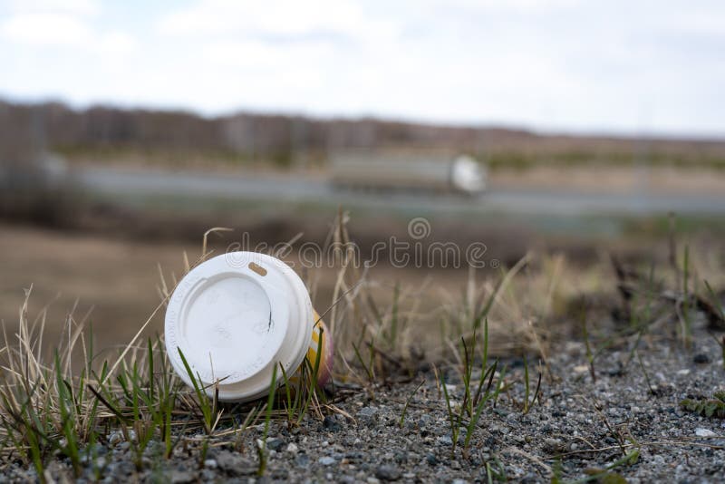 Plastic Waste on the Side of the Road in the Grass. Used Coffee Cup ...