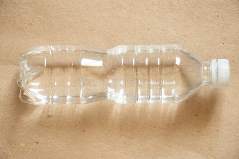 Plastic Water Bottle Lies on Brown Paper, Water Bottle Stock Image ...