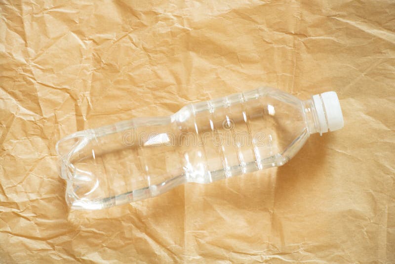 Plastic Water Bottle Lies on Brown Paper, Water Bottle Stock Photo ...