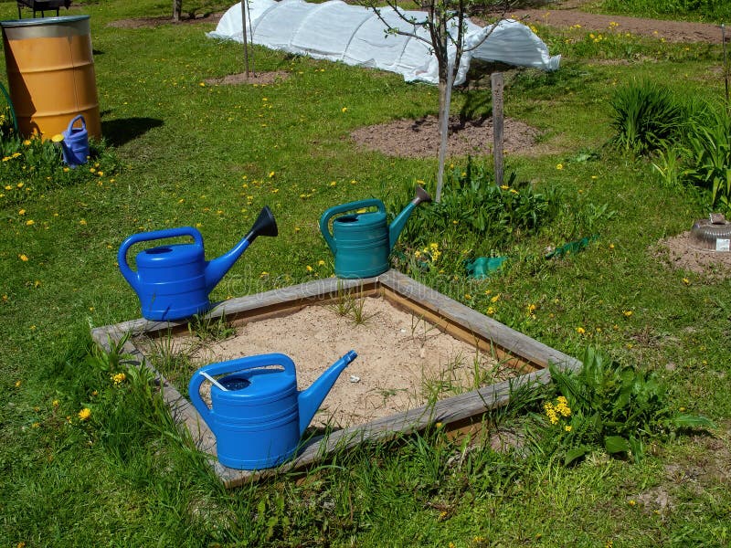 Plastic Watering Cans in the Garden Stock Image - Image of fresh ...
