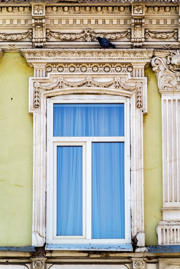 A Plastic Window in the Wall of an Old Building with Stucco Molding, a ...