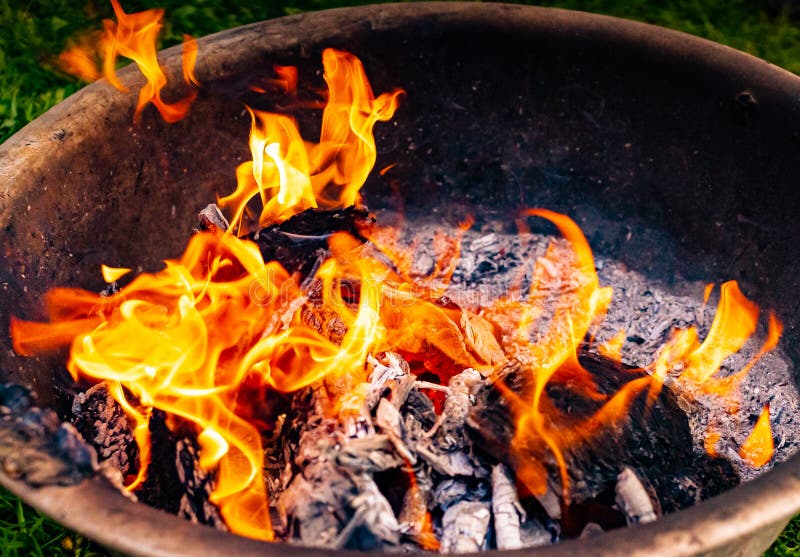 Plastic and Wood Burn in an Iron Container on the Grass Stock Photo ...