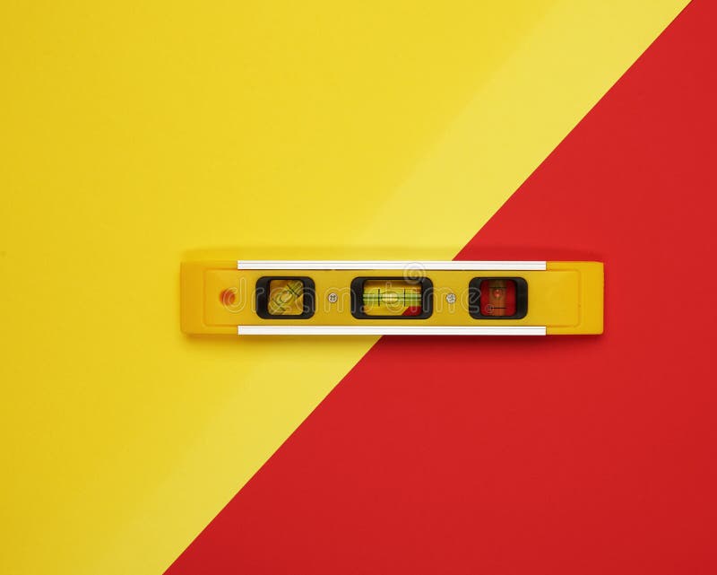 Plastic Yellow Level Tool with Capsules on Red Background Stock Image ...