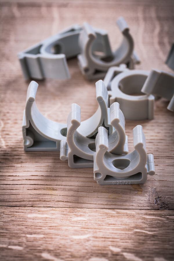 Plastical Fixators for Water Pipes on Wooden Board Stock Photo - Image ...