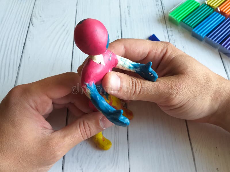 Plasticine Modeling. Hands of a Male Master Hold a Human Figure from ...