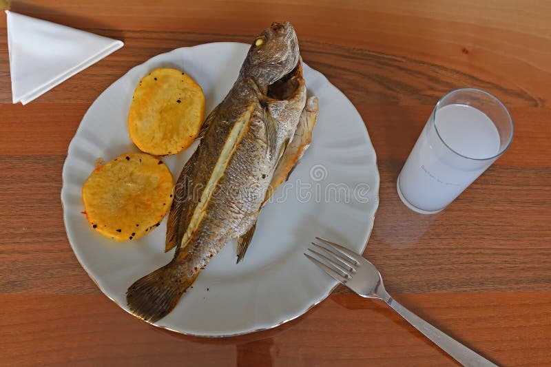 A Plate of Baked Fish and Fried Potatoes Stock Image - Image of turkish ...