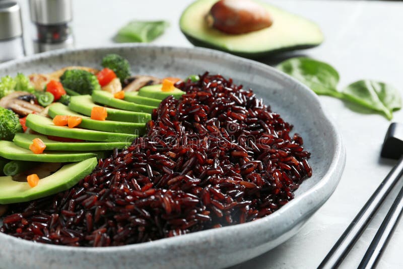 Plate of Boiled Brown Rice with Avocado on Table, Stock Photo - Image ...