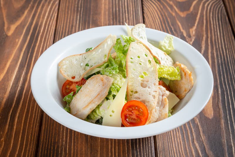 Plate of Caesar Salad with Chicken on Wooden Table Stock Photo - Image ...