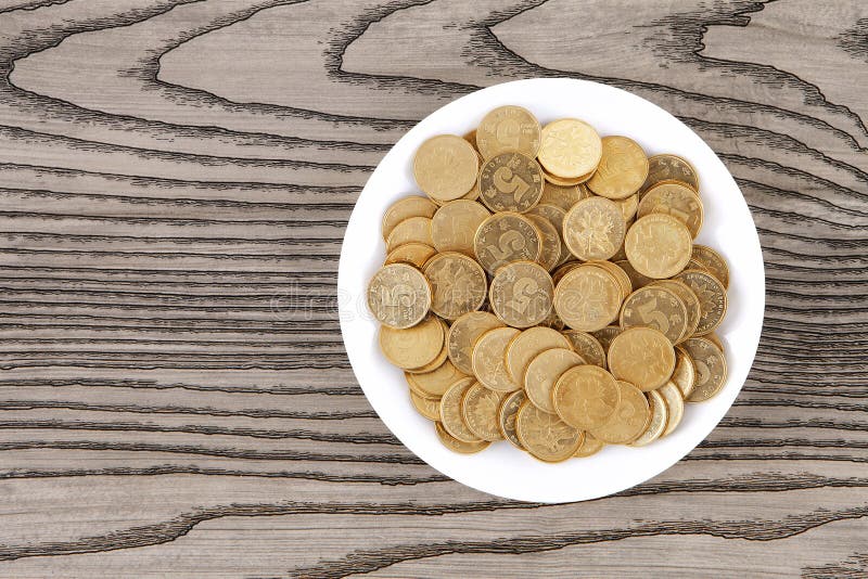 A plate of coins on table stock image. Image of coins - 231894337