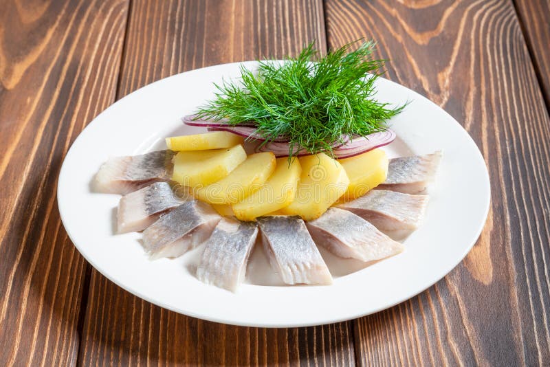 Plate of Cold Appetizers. Herring with Boiled Potatoes and Red Onion ...