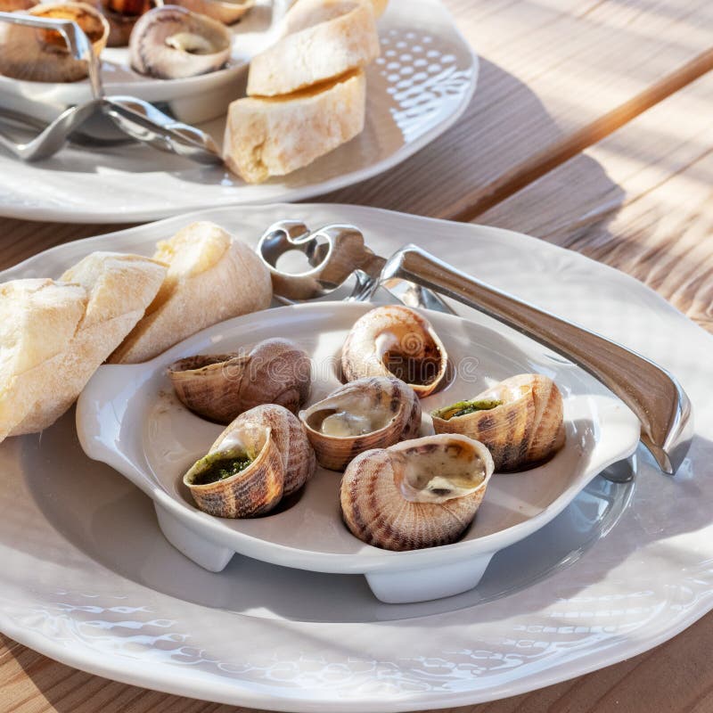 Plate with Cooked Snails in a Rustic Restaurant Closeup Stock Image ...