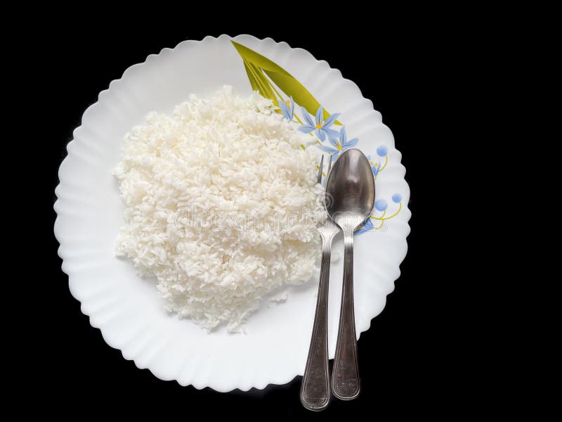 A Plate of Cooked Steam Rice with Fork and Spoon Display on Black ...