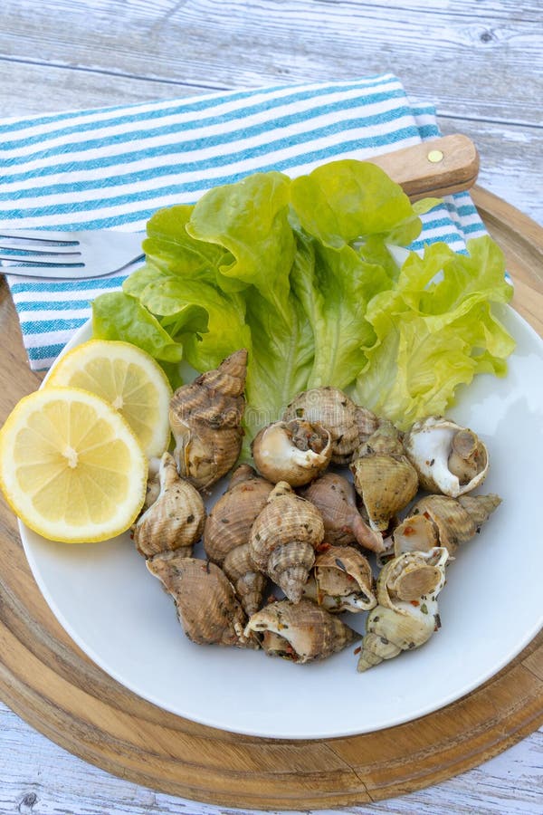 Of Cooked Whelks on a Plate with Salad and Lemon Stock Image - Image of ...