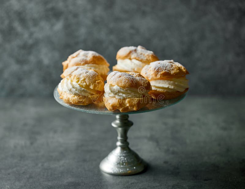 Plate of cream puffs stock photo. Image of decorative - 266962772