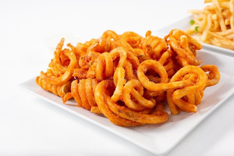 Plate of curly fries stock image. Image of dish, fork - 276722711