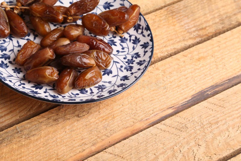 A Plate of Dates on a Wooden Table Stock Image - Image of healthy, food ...