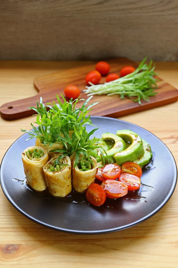 Plate of Delectable Egg Rolls with Fresh Water Spinach Microgreens ...