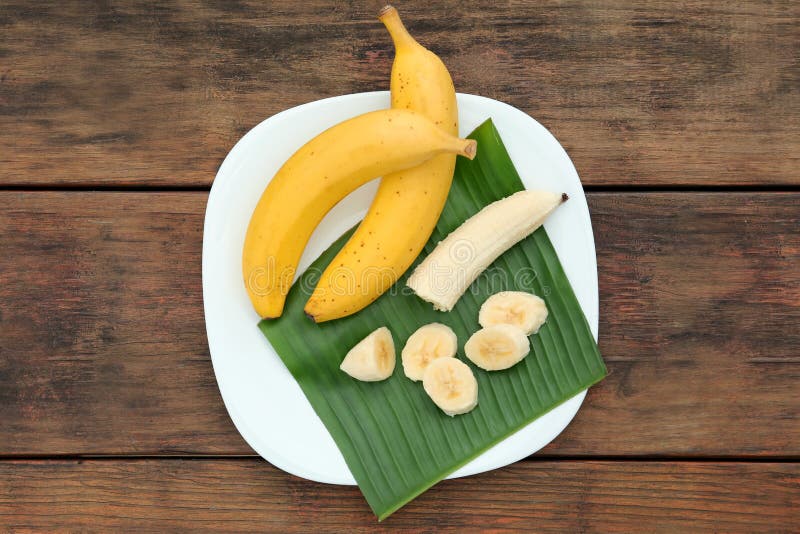 Plate with Delicious Bananas and Fresh Leaf on Wooden Table, Top View ...