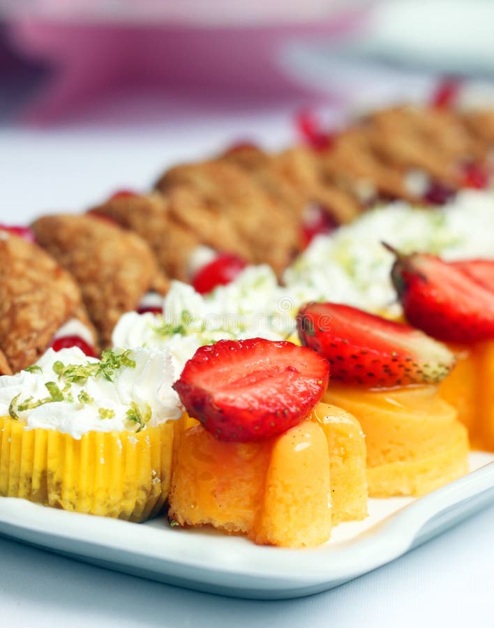 Plate with delicious cakes stock image. Image of closeup - 58722399