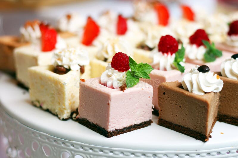 Plate with delicious cakes stock photo. Image of icing - 58860124