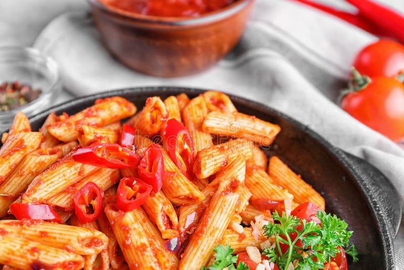 Plate with Delicious Penne Pasta and Garnish on Table, Closeup Stock ...