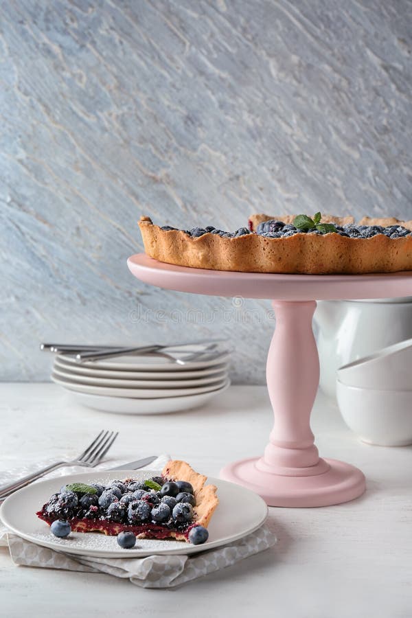Plate and Dessert Stand with Delicious Blueberry Pie on Table Stock ...