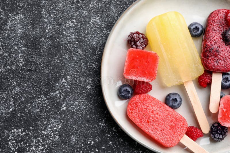 Plate of Different Fruit Ice Pops on Black Textured Table, Top View ...