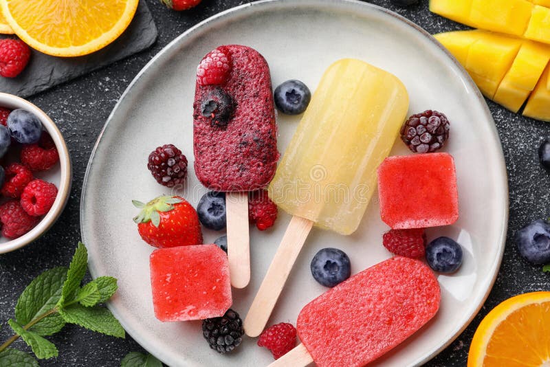 Plate of Different Tasty Ice Pops on Black Textured Table, Flat Lay ...