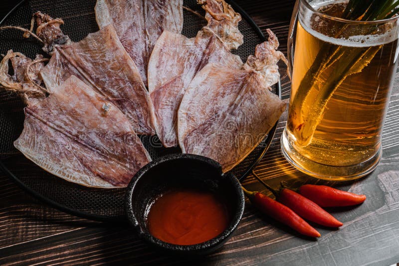 Plate with Dried Squid Sauce, and a Cold Beer on a Table Stock Image ...