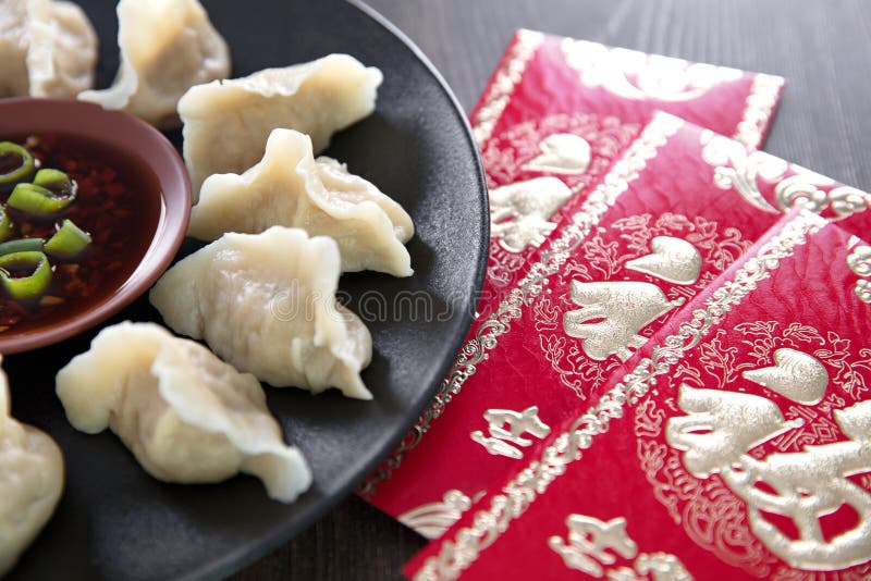 A Plate of Dumplings and Red Packets Stock Image - Image of spring ...