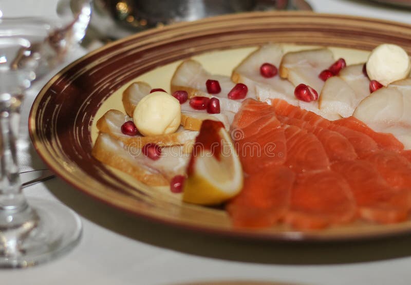 Plate of Fish Appetizers. Decorated with Cheese, Pomegranate Seeds ...
