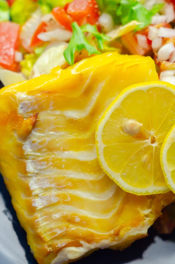 A Plate of Food with a Fish and a Lemon on it Stock Photo - Image of ...