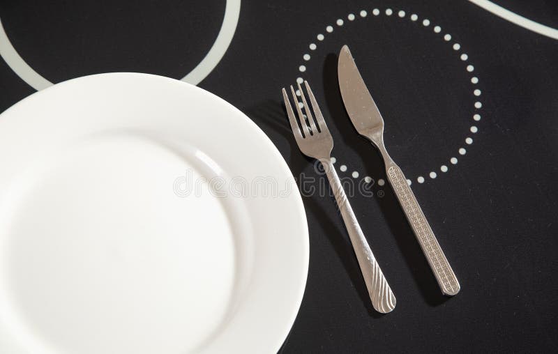 Plate with a Fork and Knife on the Kitchen Table Stock Image - Image of ...