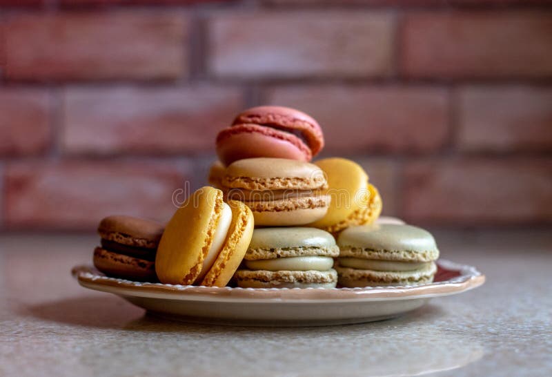 Plate of French Macarons Against a Brick Back Ground Stock Image ...