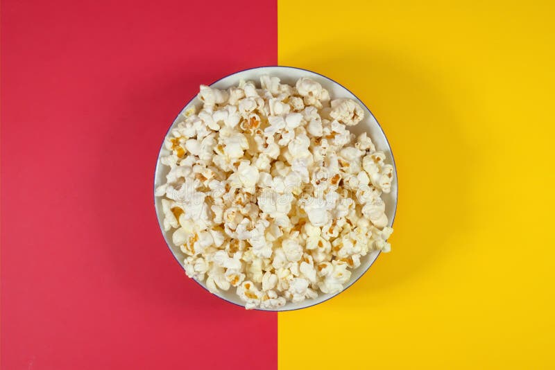 Plate of Fresh Popcorn on a Colored Paper Background. View from Above ...