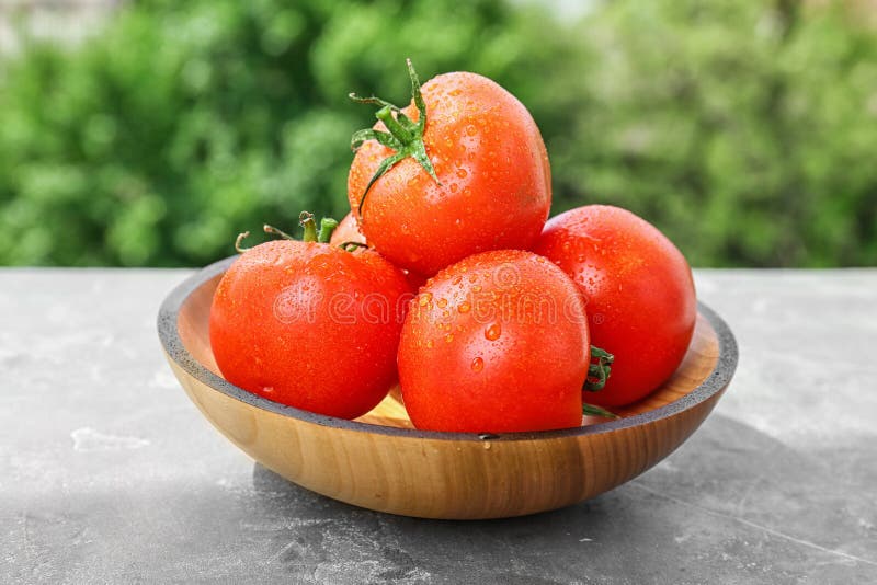 Plate with Fresh Tomatoes on Table Outdoors Stock Photo - Image of ...