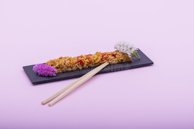 Plate of Fried Rice Decorated with Flowers on a Pink Background Stock ...