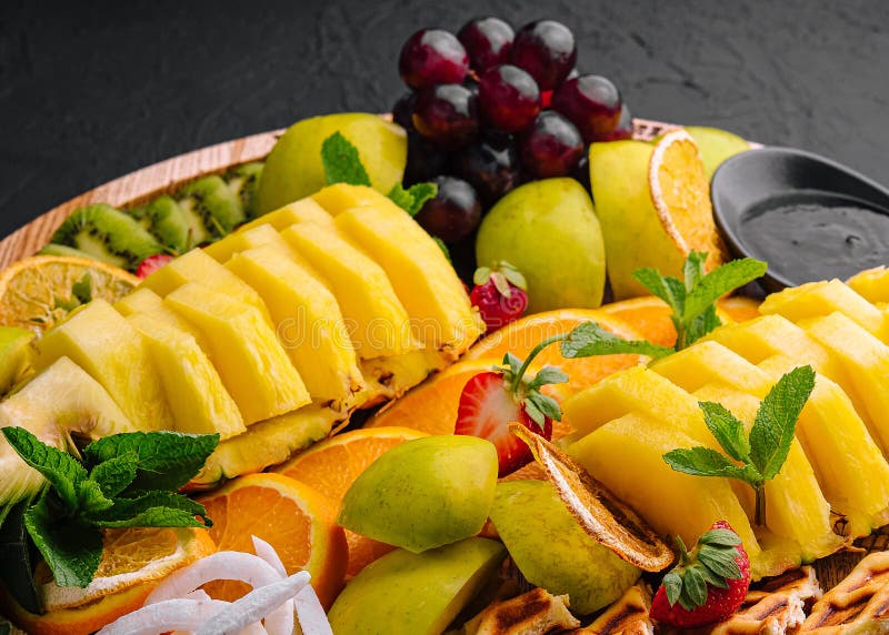 A Plate of Fruit Assorted on Black Stone Stock Photo - Image of ...