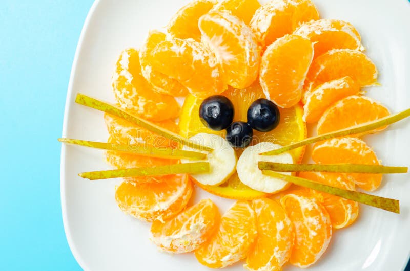 A Plate of Fruit with a Face Lion Drawn on it Stock Photo - Image of ...