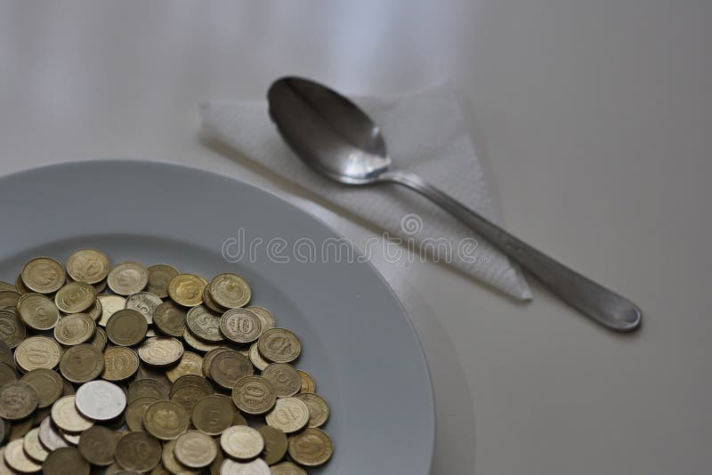 A Plate Full of Coins on a Table and a Spoon Next To it, Spending Money ...