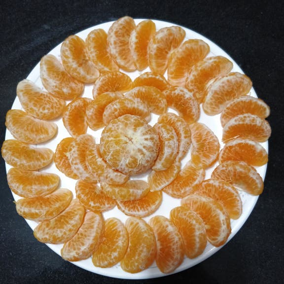 Plate Full of Kinnow Segments and a Peeled Kinnow Stock Image - Image ...